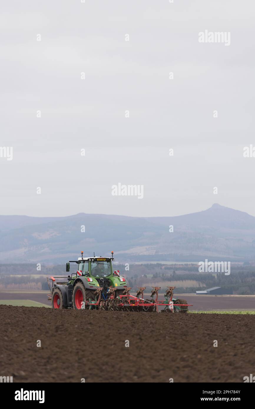 A Green Fendt Tractor with a Reversible Plough Trailing a Kverneland ...