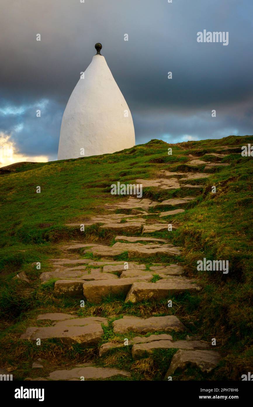 A stone path leads up to White Nancy a folly constructed to commemorate ...