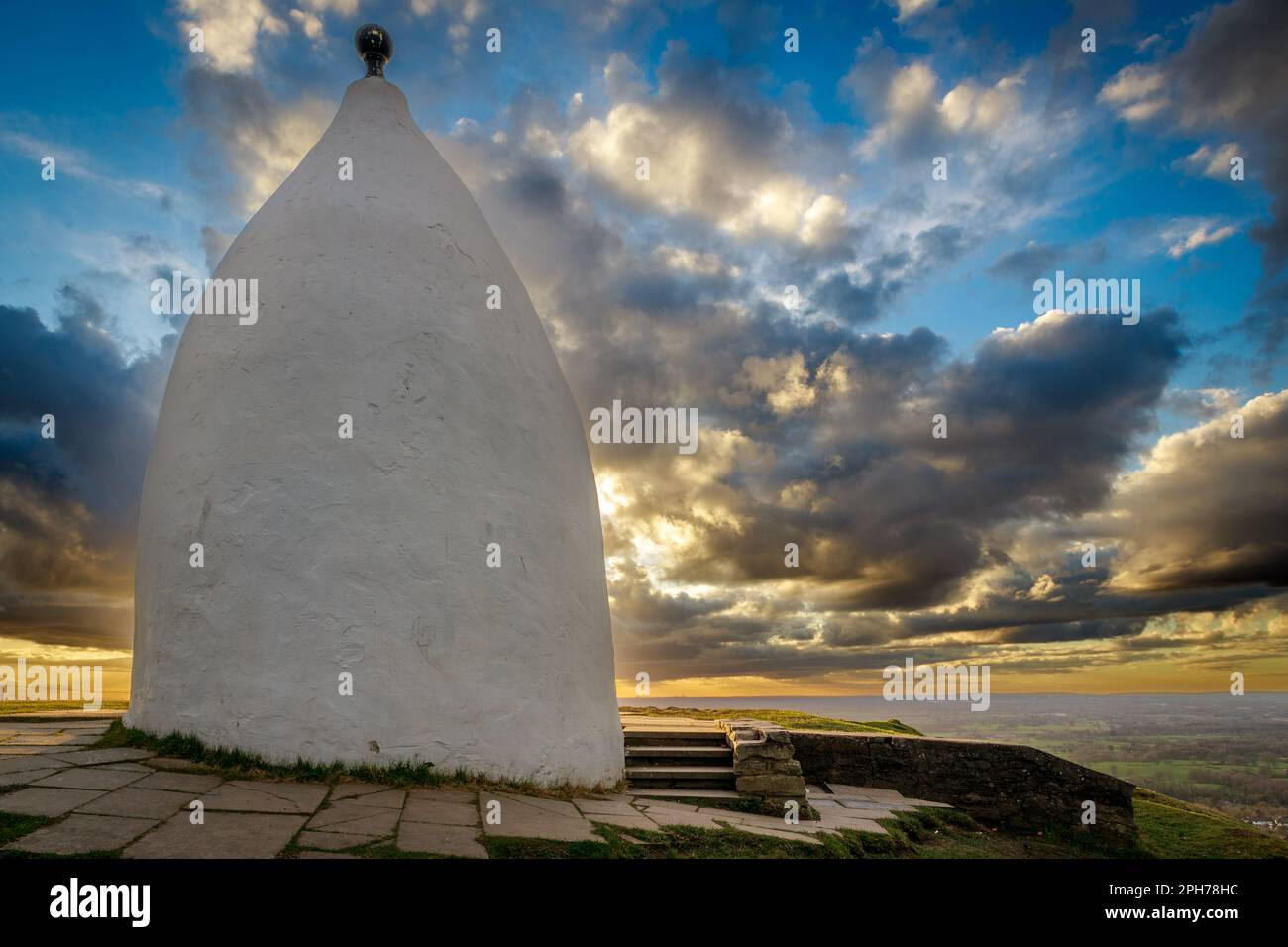 A dramatic sunset obstructed by White Nancy a folly constructed to ...
