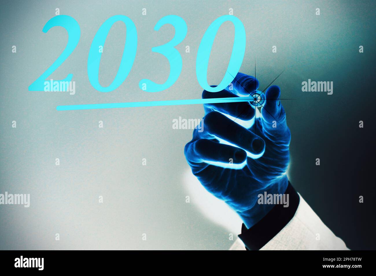 Hand of a business man writing the year “2030” with a red pen Stock ...
