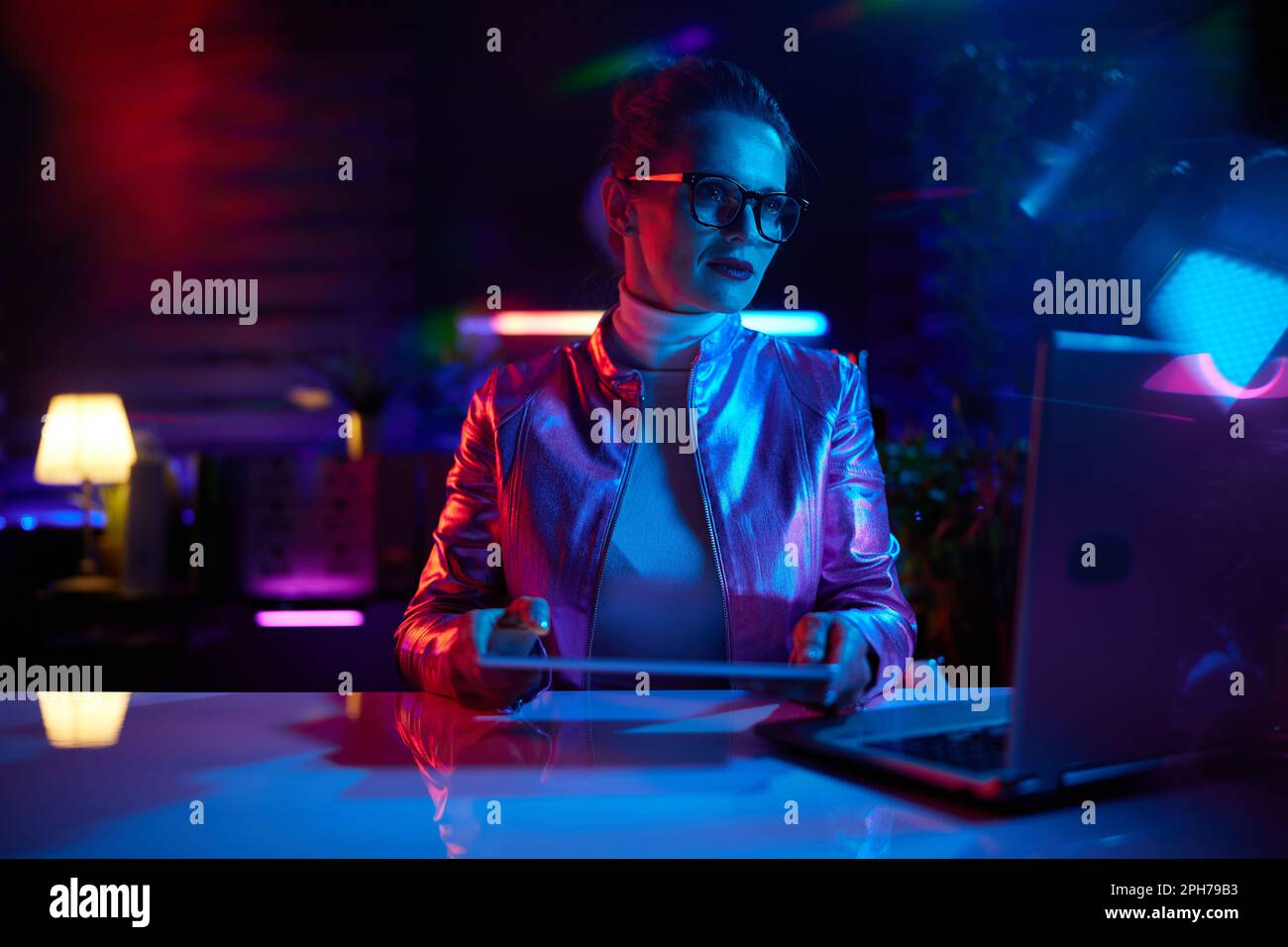 Neon metaverse futuristic concept. pensive modern 40 years old woman in ...