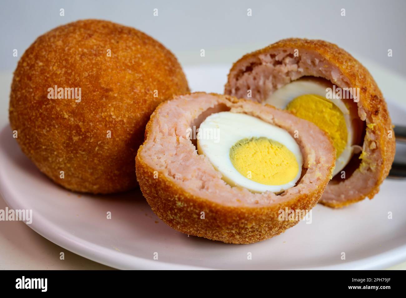 Traditional street food in UK, stuffed fried Scotch eggs with ...