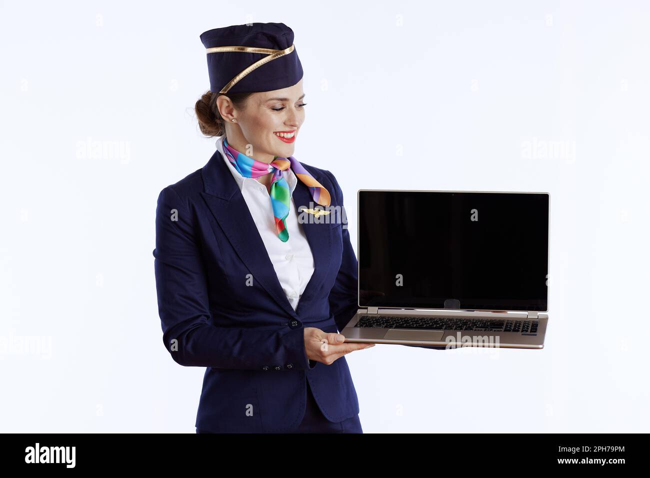 smiling stylish female air hostess against white background in uniform ...
