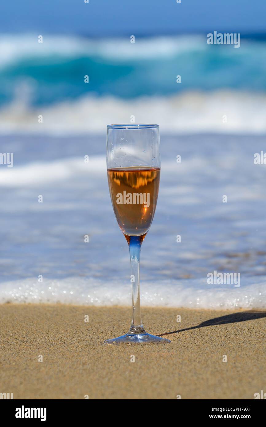One glass of rose champagne or cava sparkling wine served on white ...