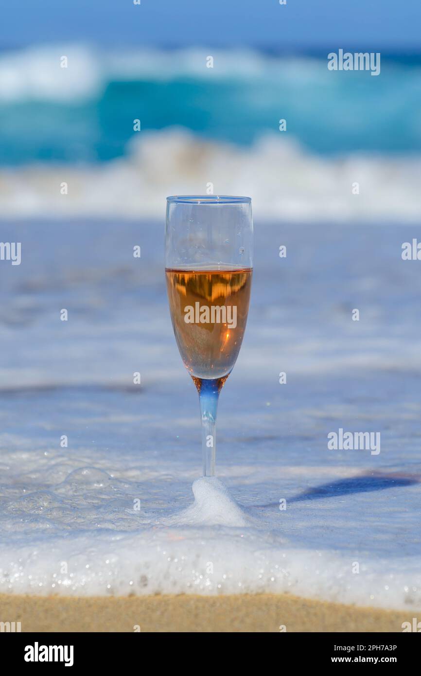 One glass of rose champagne or cava sparkling wine served on white ...