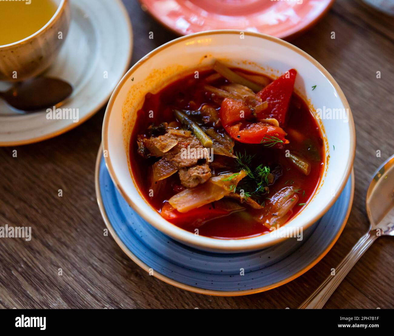 Traditional Laghman with pulled noodles, meat and vegetables Stock ...