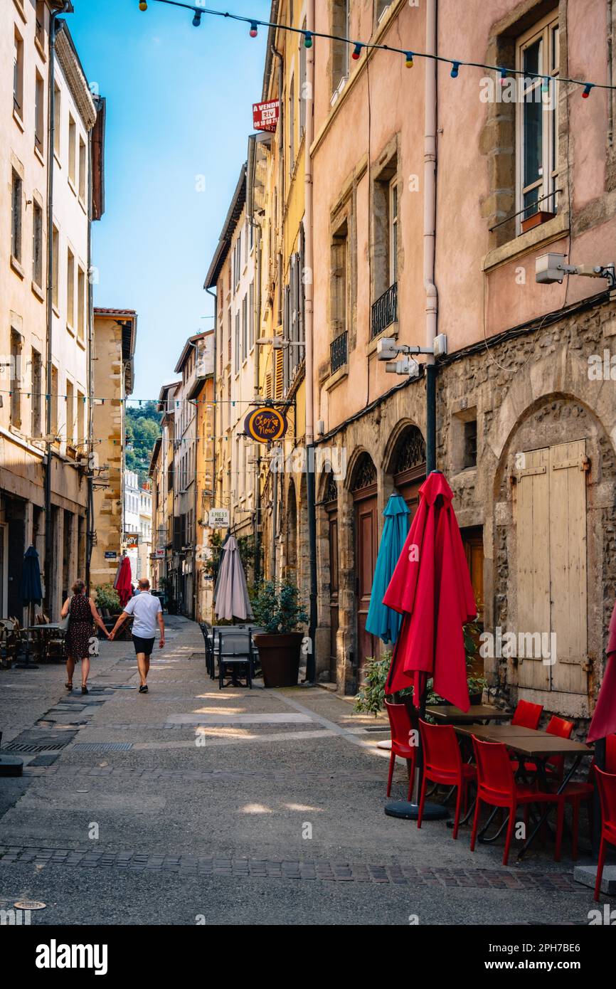 Couple holding hands in the Rue des Clercs, a cute street in Vienne's ...