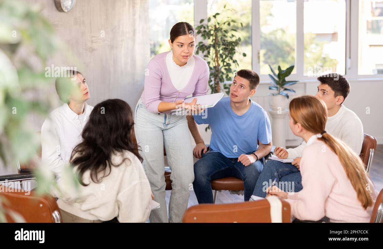 Group of students engaged in discussion in classroom Stock Photo - Alamy