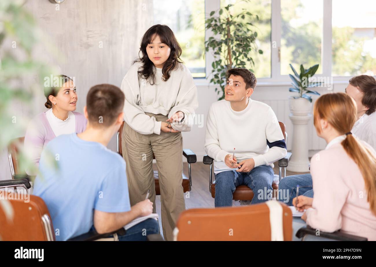 Young Asian female student taking part in group discussion Stock Photo ...