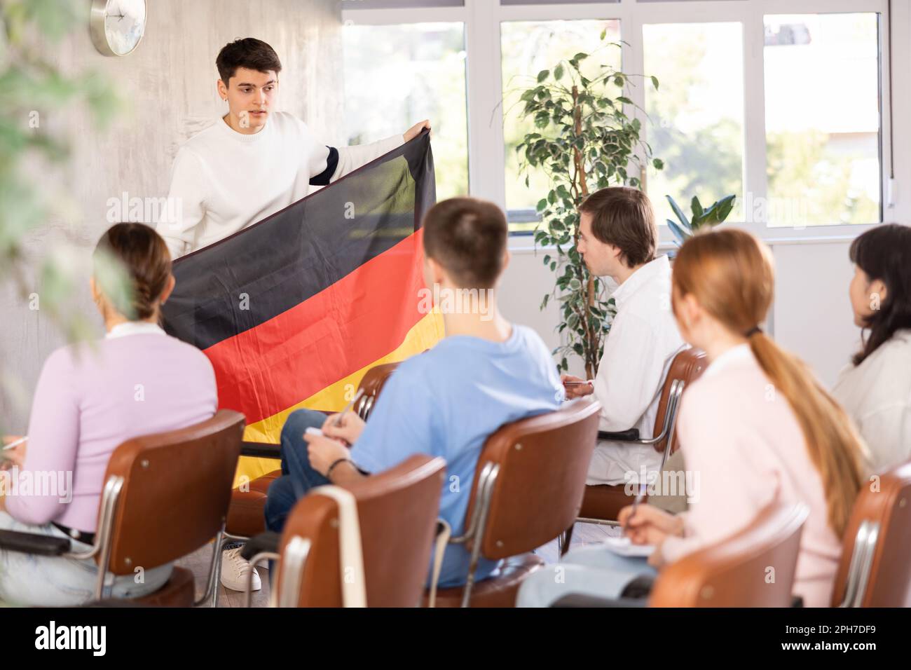 Young man tells his classmates the history of the state of Germany ...