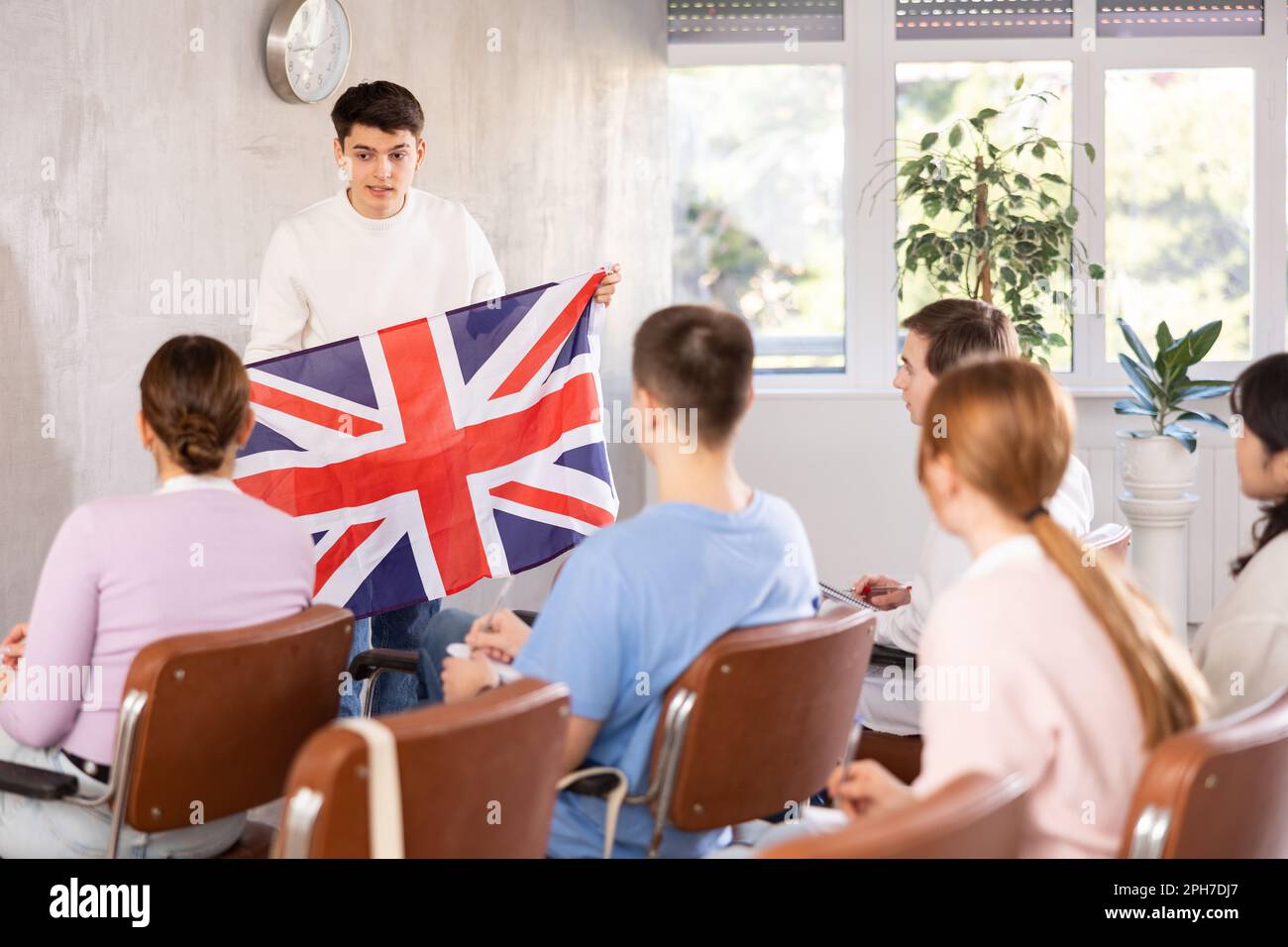 Young male professor showing british flag to group of students Stock ...