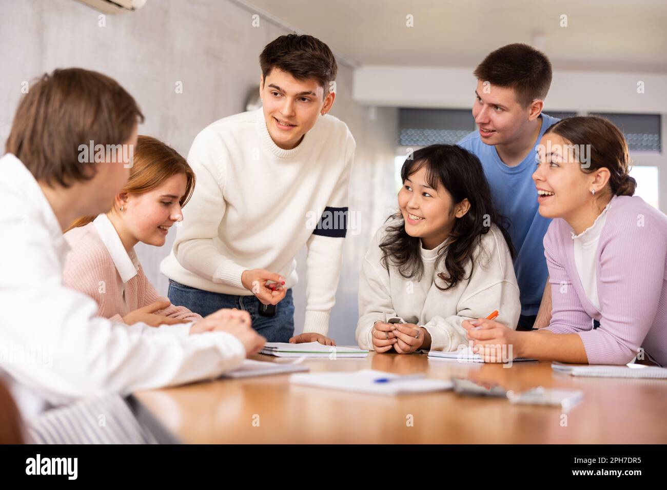 Group of students studying for difficult test in studygroup together ...