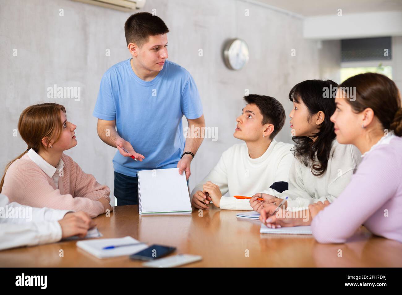 Group of girls and boys studying in classroom school, sitting around ...