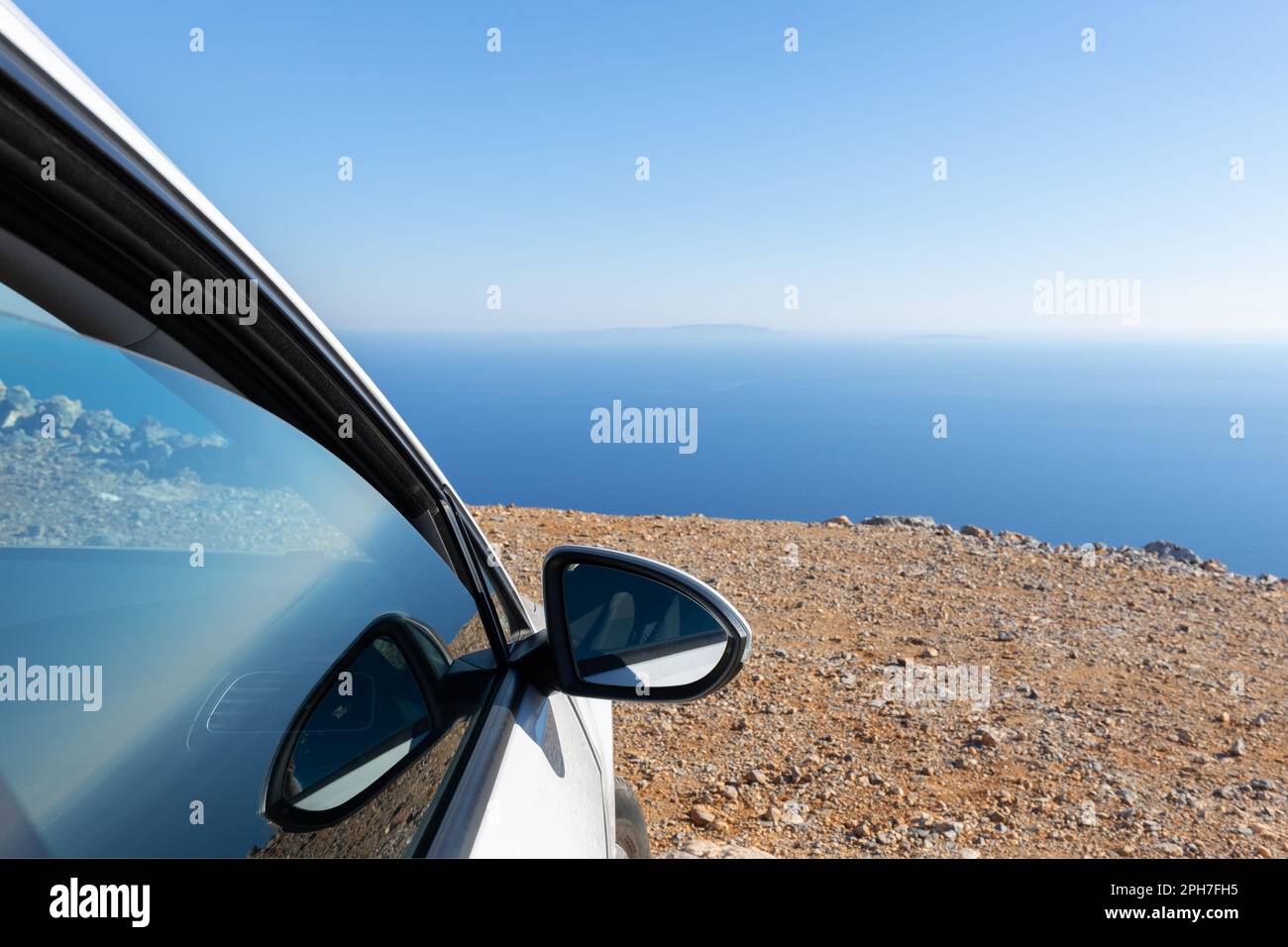 The car stands on a high shore above the sea with a gorgeous view in ...