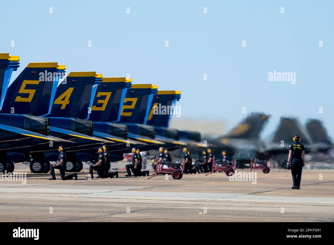 Members of the U.S. Navy Blue Angels team prepare for the jets' takeoff ...