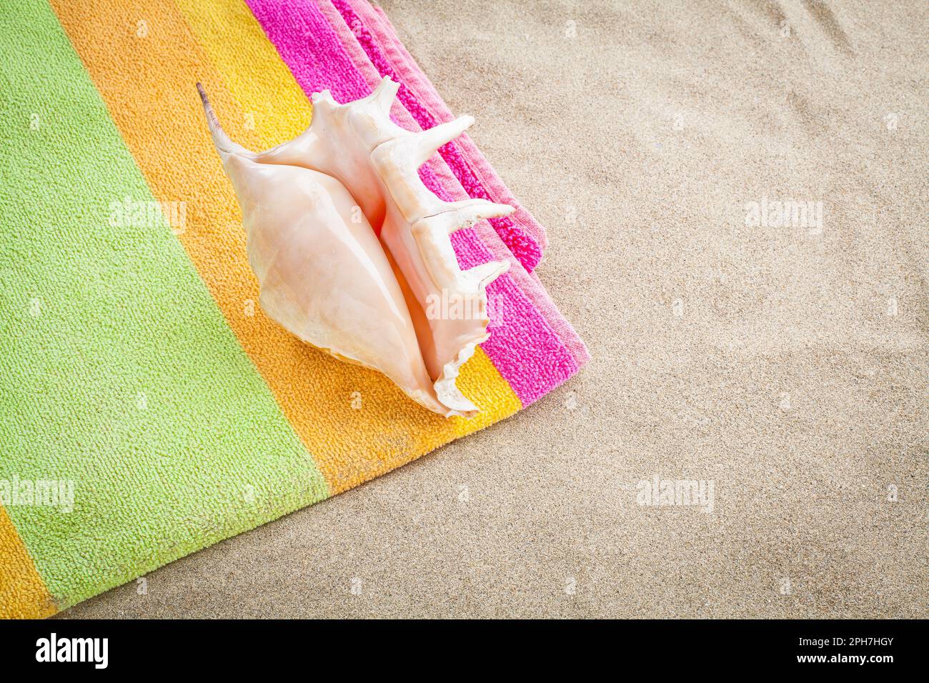 Beach towel and seashell on the beach in summer Stock Photo - Alamy
