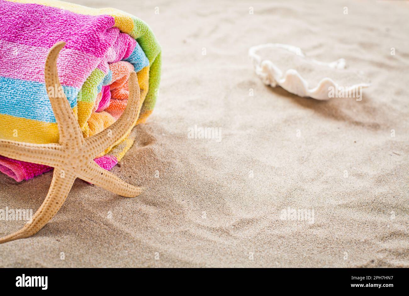 Beach towel and seashell on the beach in summer Stock Photo - Alamy
