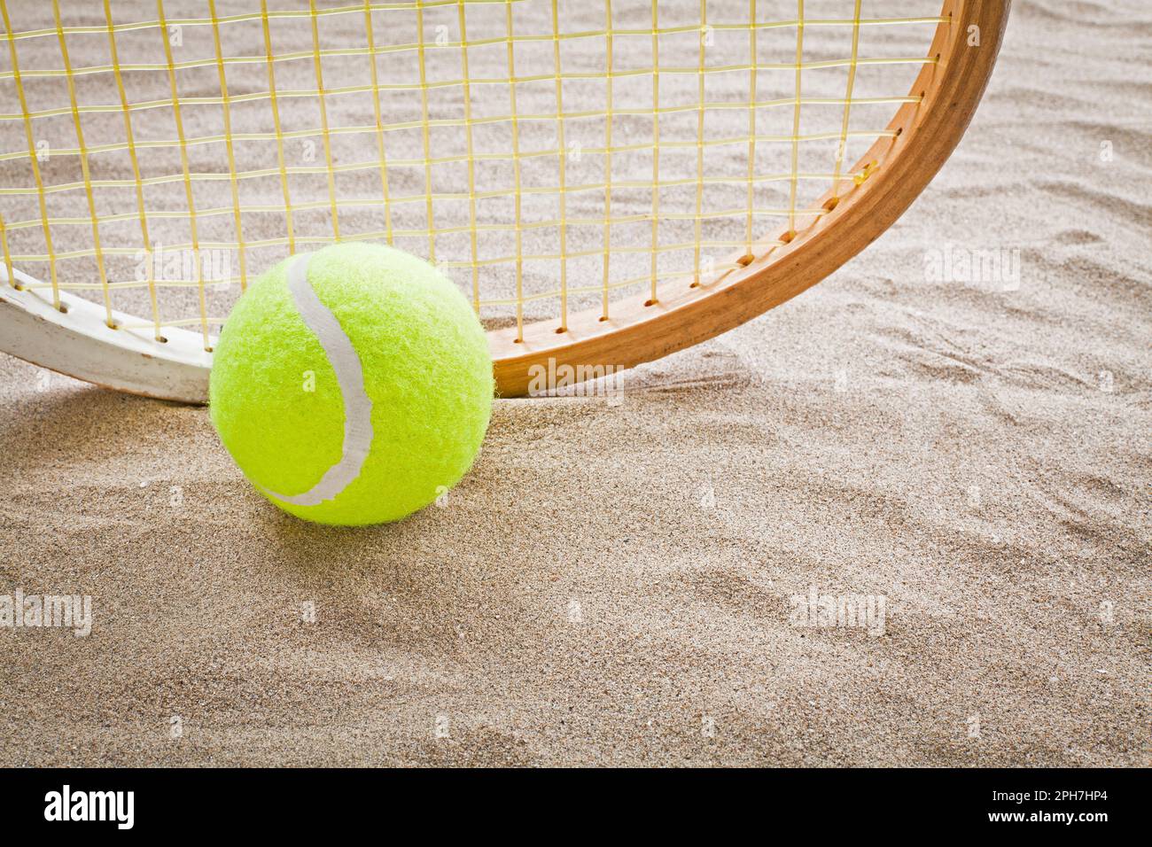 Tennis racket and ball on the sand in summer Stock Photo - Alamy
