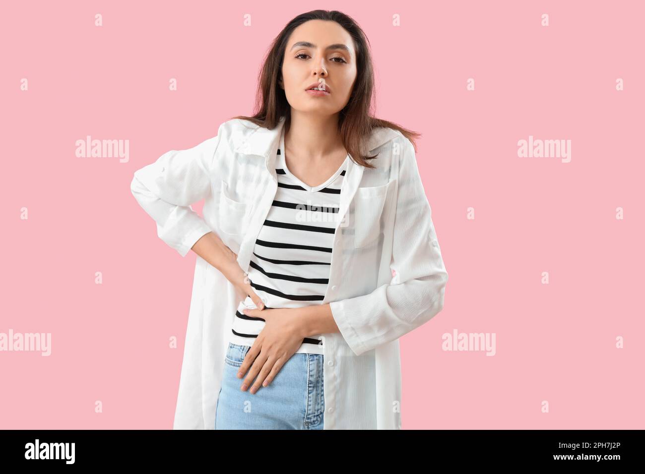 Young woman with appendicitis on pink background Stock Photo - Alamy