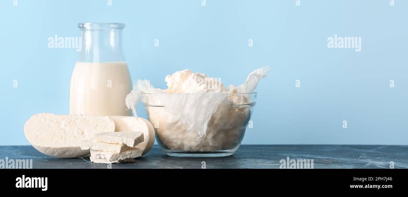 Different fresh dairy products on light blue background with space for ...