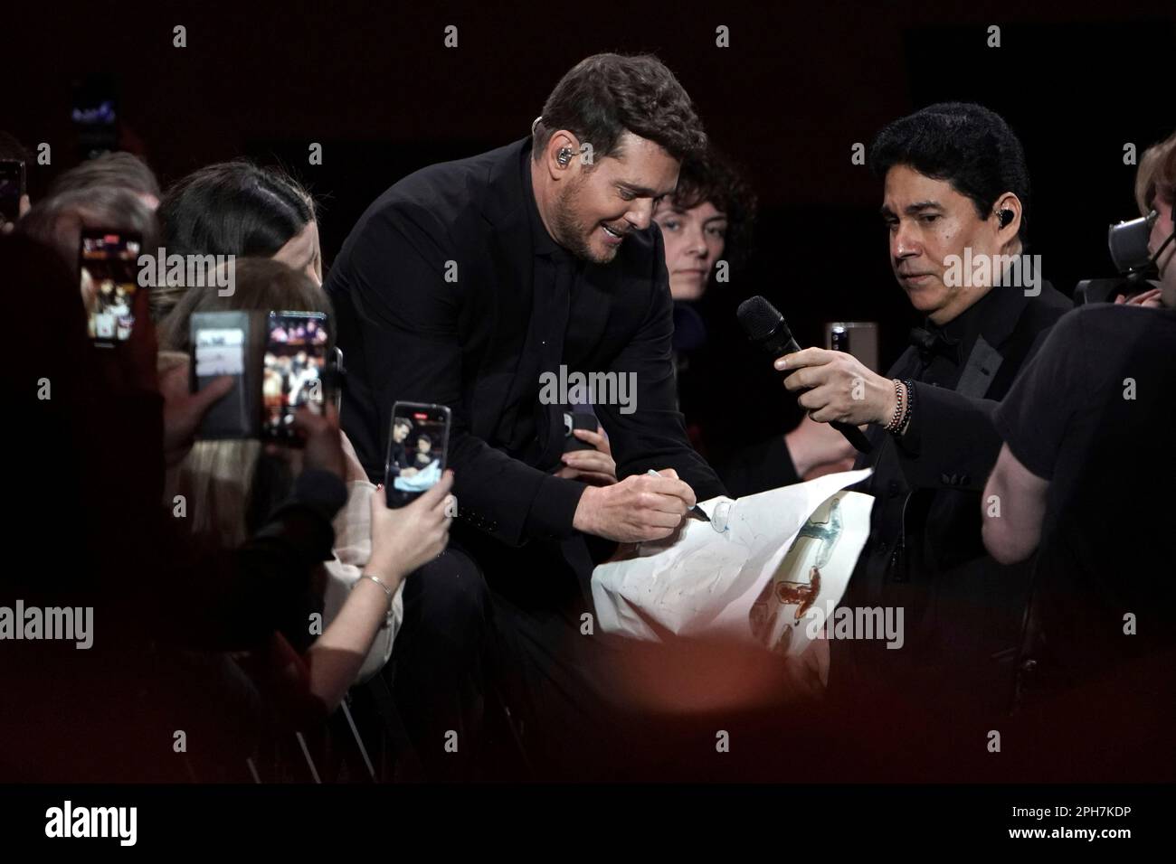 Michael Buble signs an autograph whilst performing at the O2 Arena in ...
