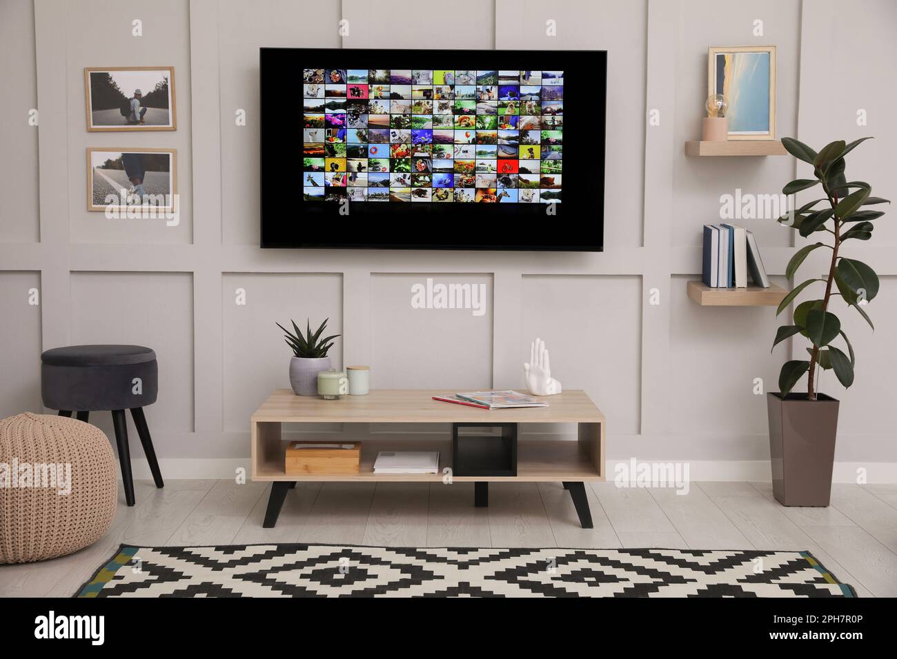 Stylish living room interior with modern TV on white wall Stock Photo ...