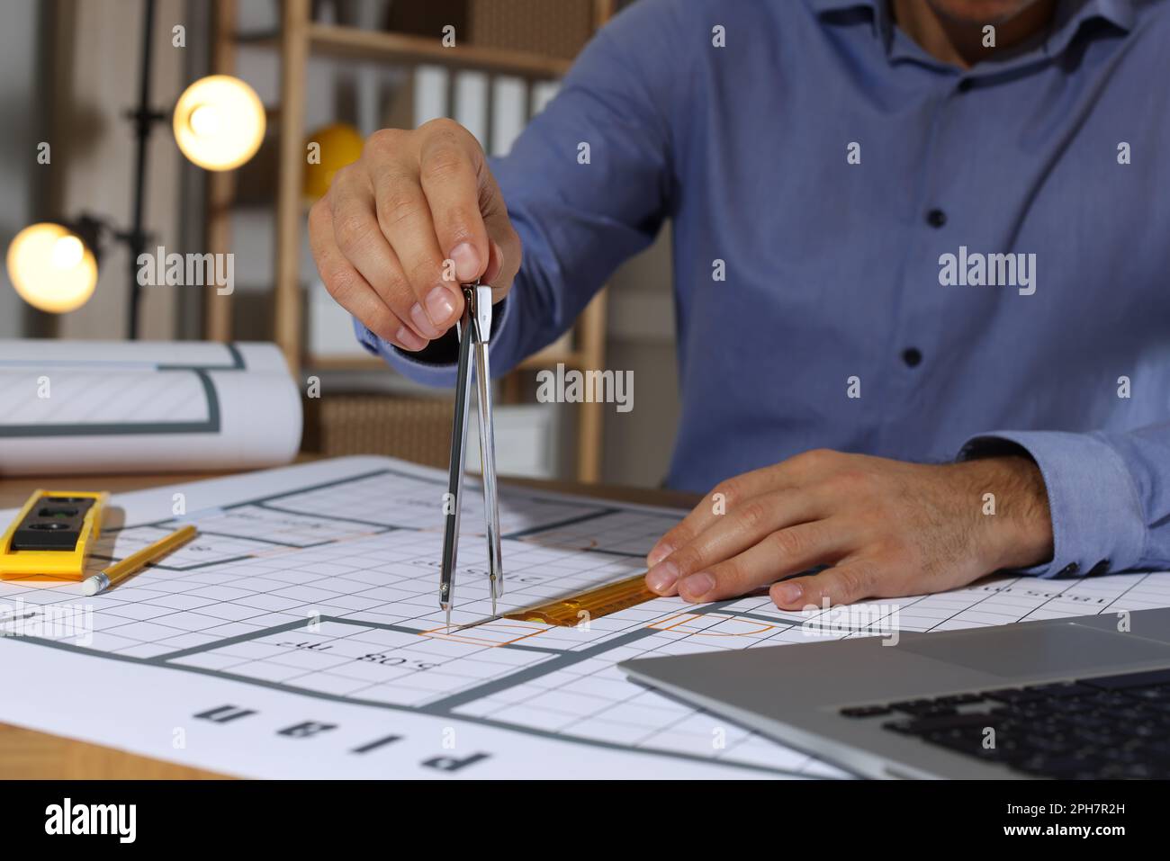 Architect working with construction drawings in office, closeup Stock ...