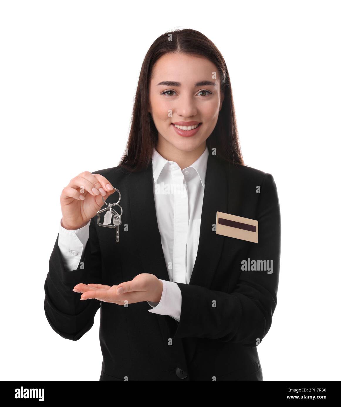 Happy young receptionist in uniform holding key on white background ...