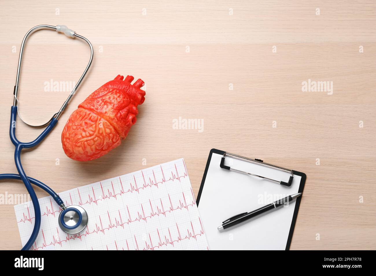 Stethoscope, cardiogram, clipboard, heart model and space for text on ...