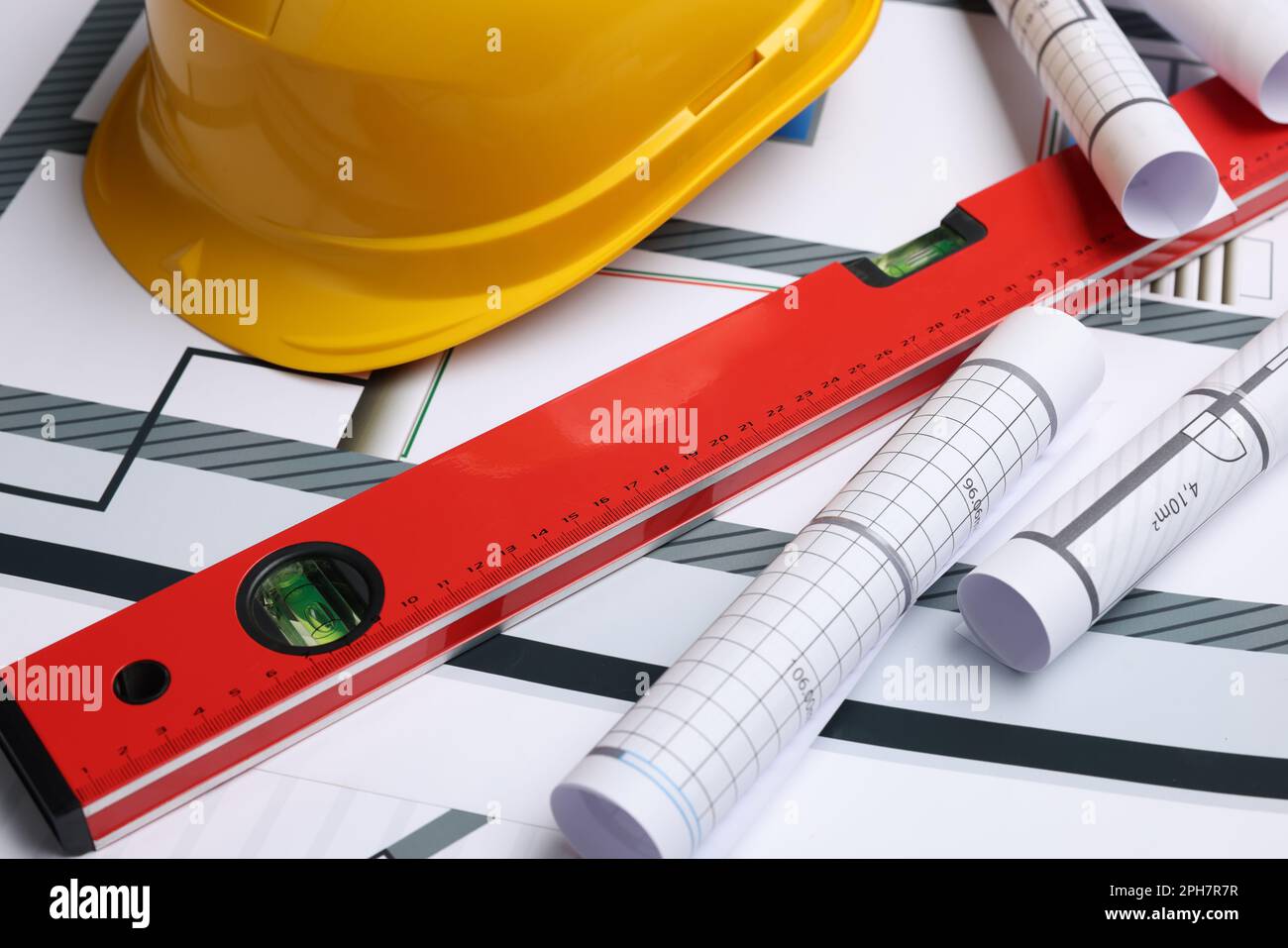 Construction drawings, safety hat and bubble level on house plan ...
