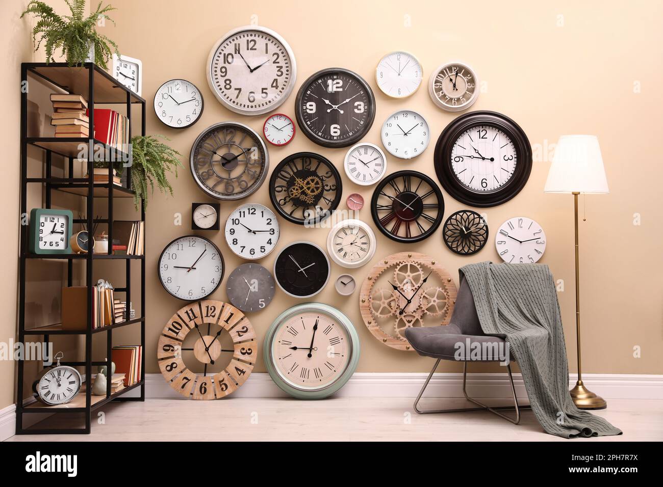 Stylish room interior with collection of wall clocks Stock Photo - Alamy