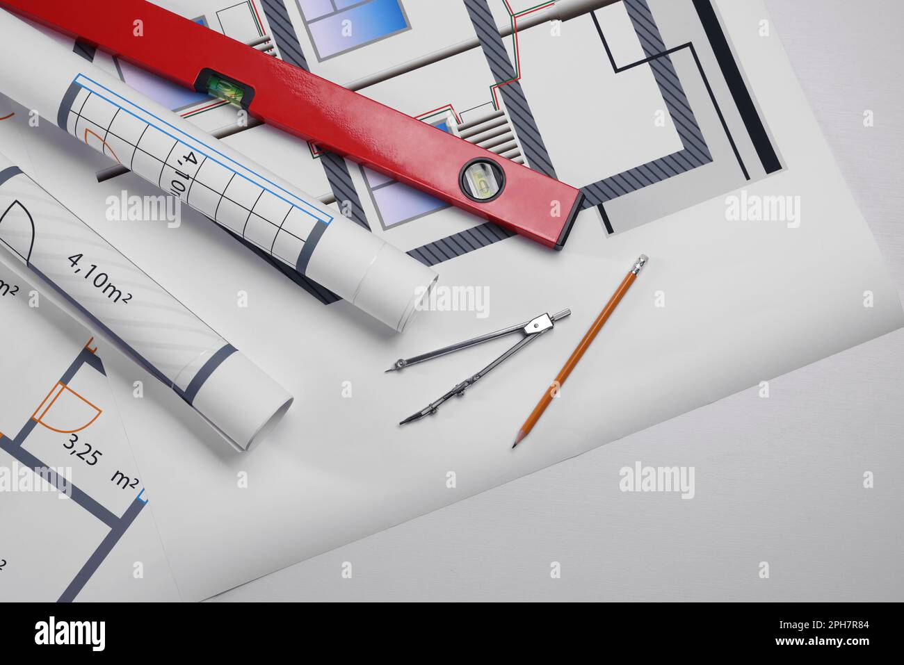 Construction drawings, pair of compasses, pencil and bubble level on ...