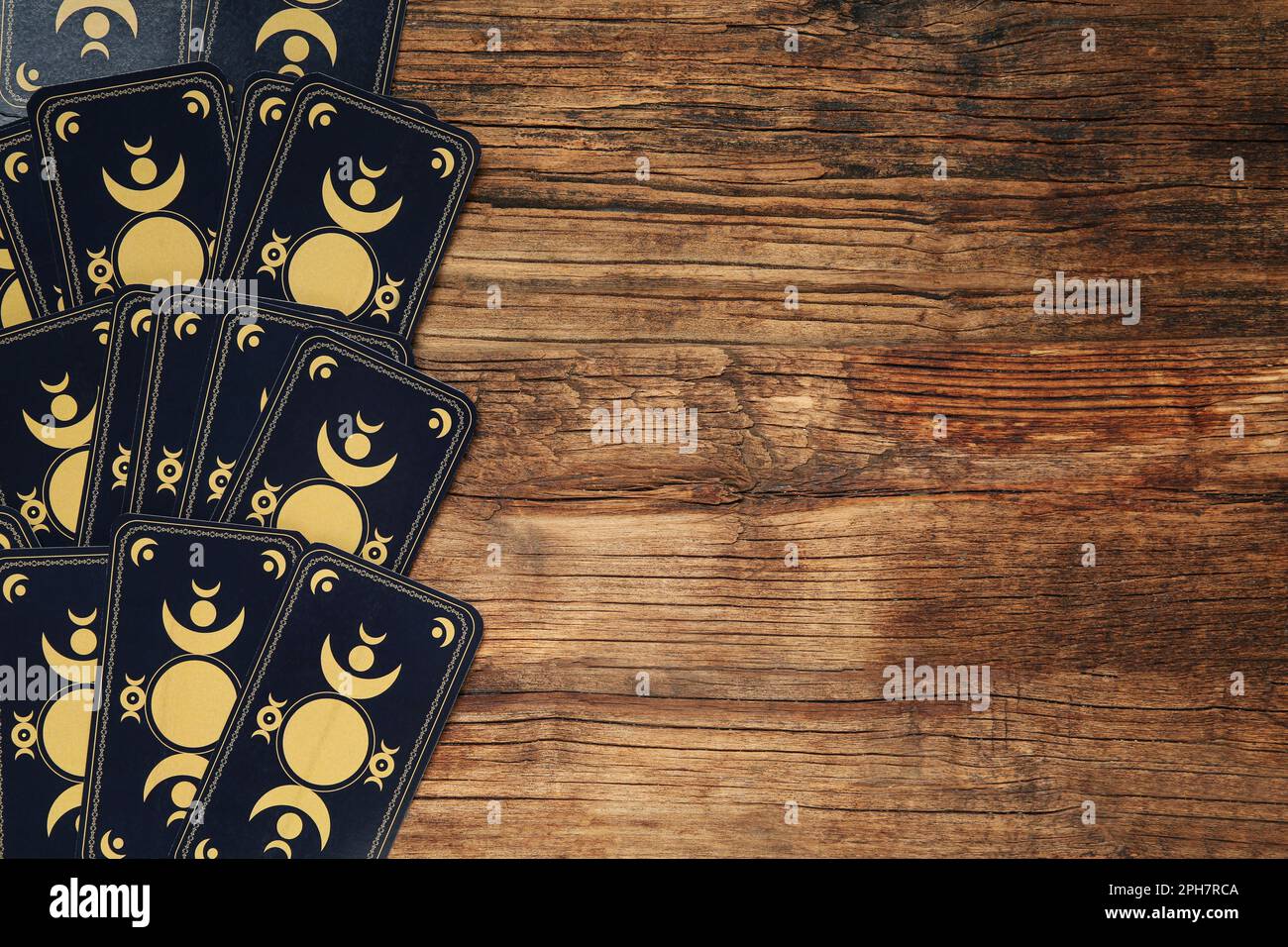 Tarot cards on wooden table, top view and space for text. Reverse side ...