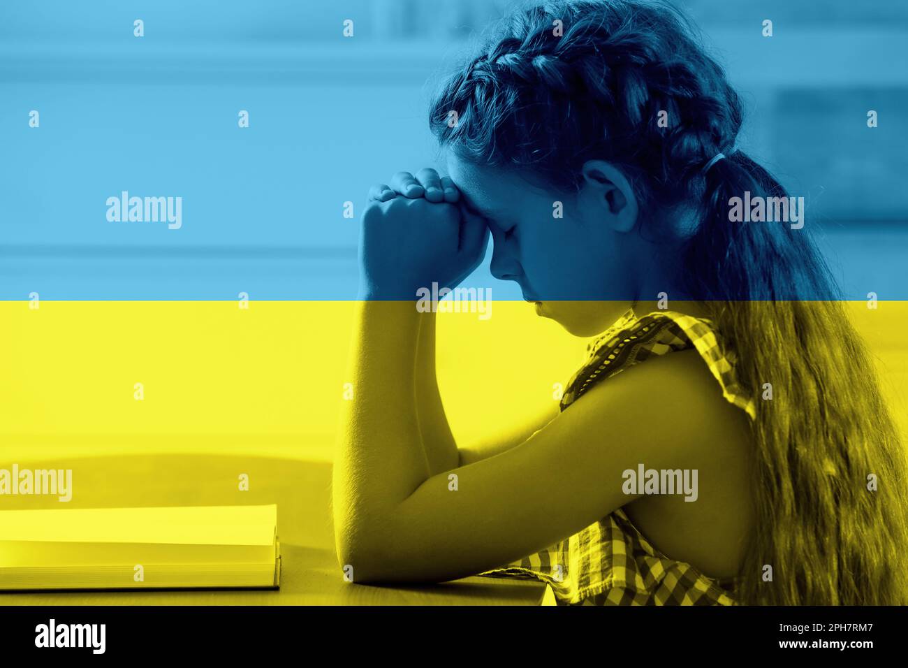 Pray for Ukraine. Double exposure of little girl with Bible praying in ...