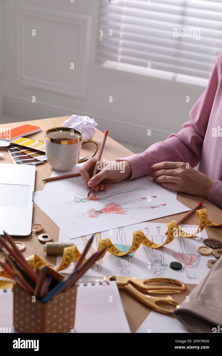 Fashion designer drawing sketch at wooden table, closeup Stock Photo ...