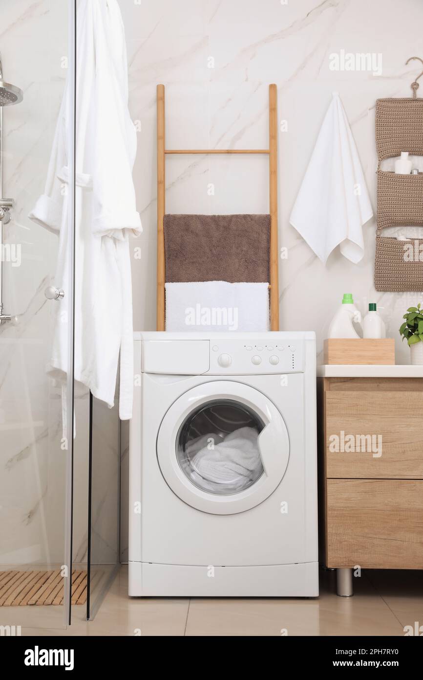 Stylish bathroom interior with modern washing machine Stock Photo - Alamy