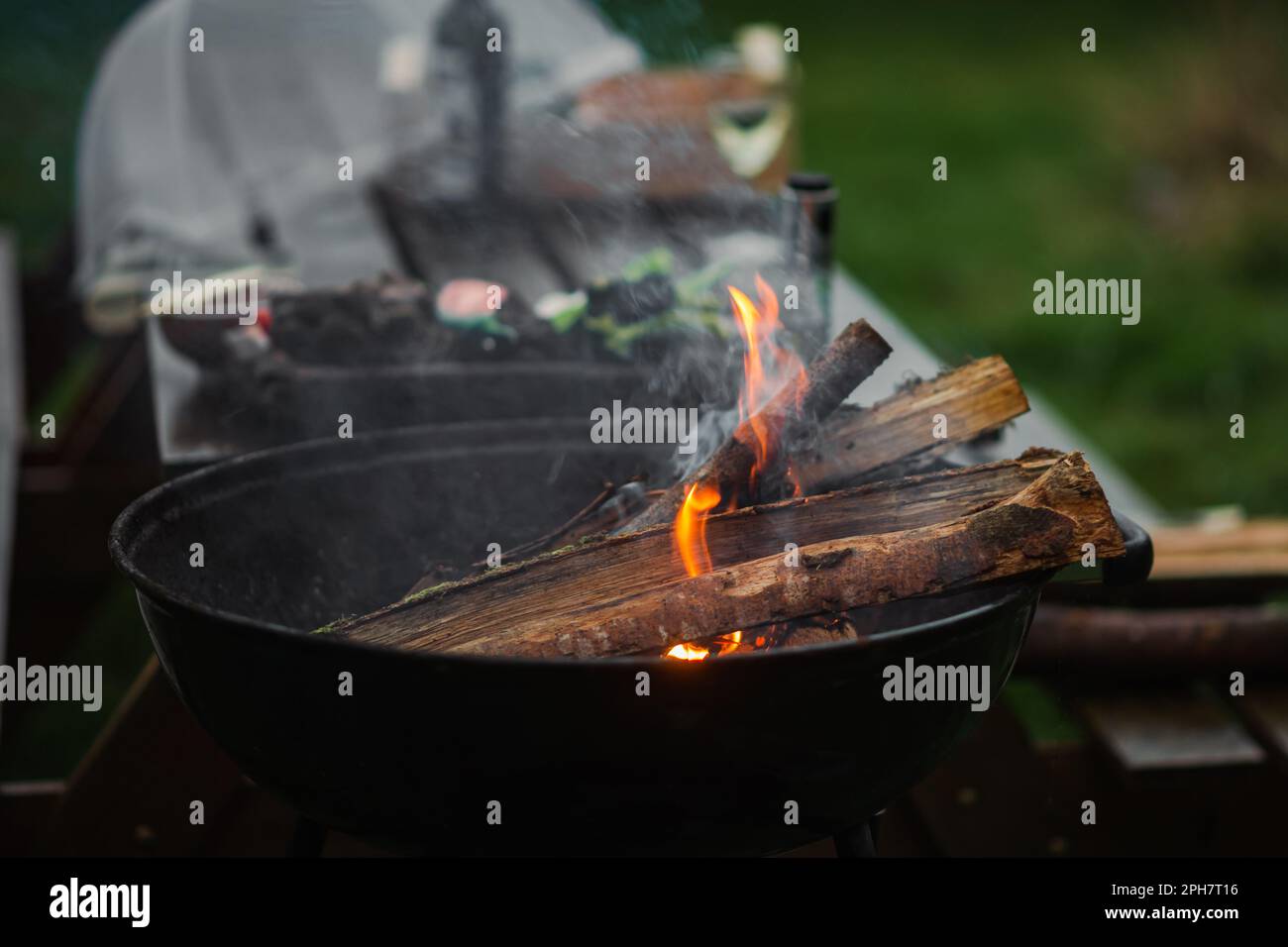 The smoking brazier of a round form. Firewood flares up in the brazier ...