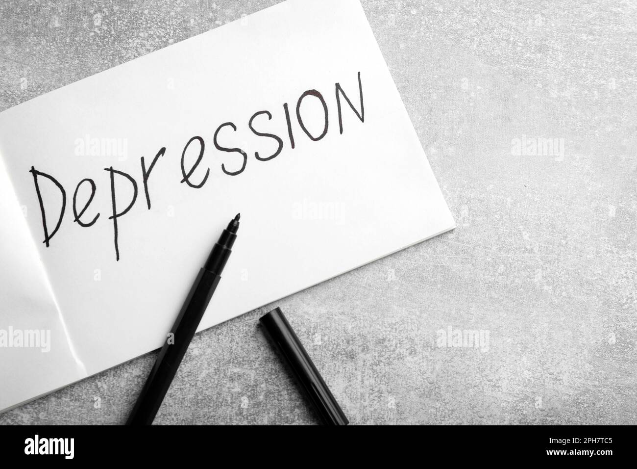 Sheet of paper with word Depression and black felt tip pen on light ...