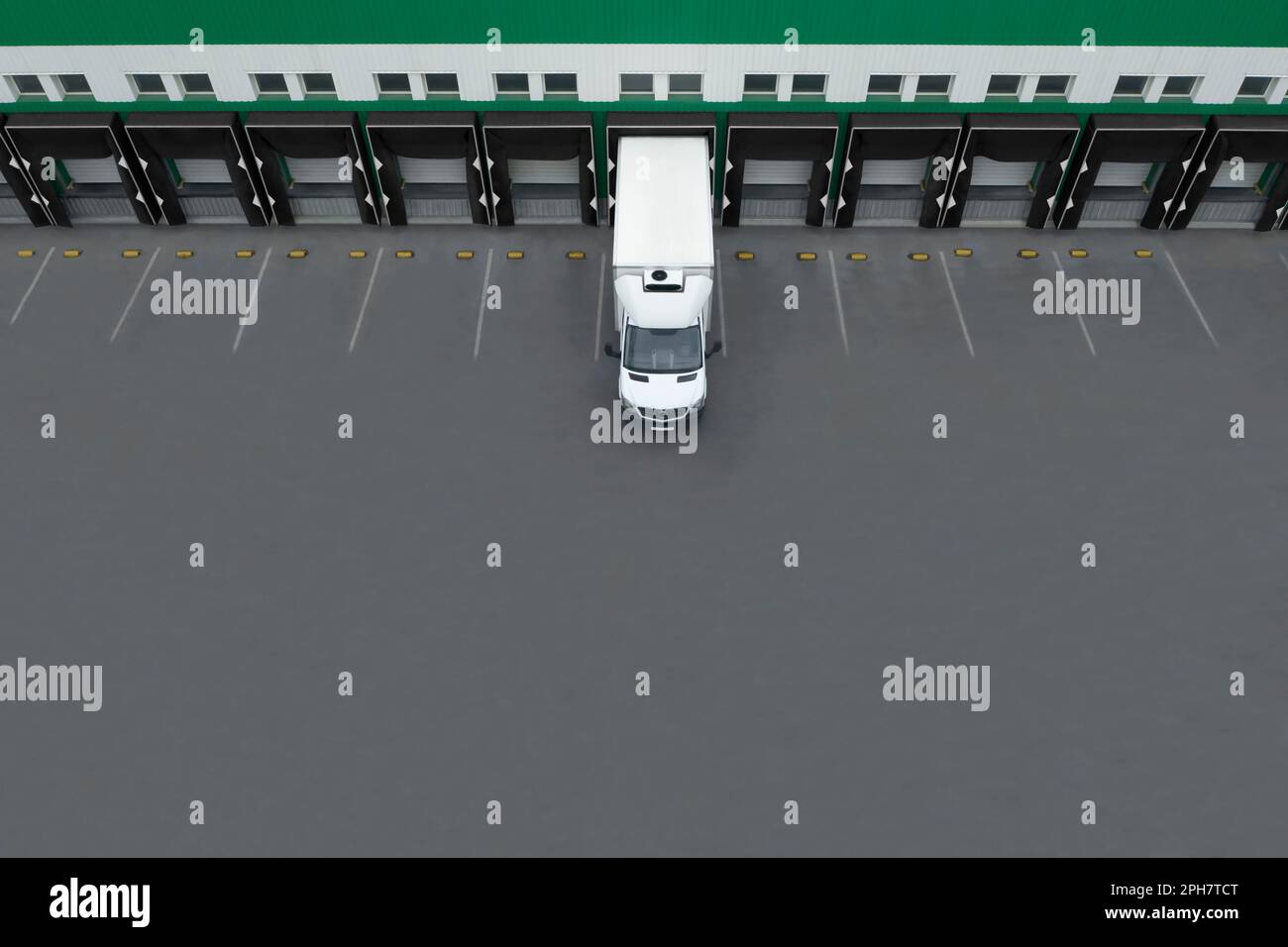 Truck near loading dock of warehouse outdoors, aerial view. Logistics ...