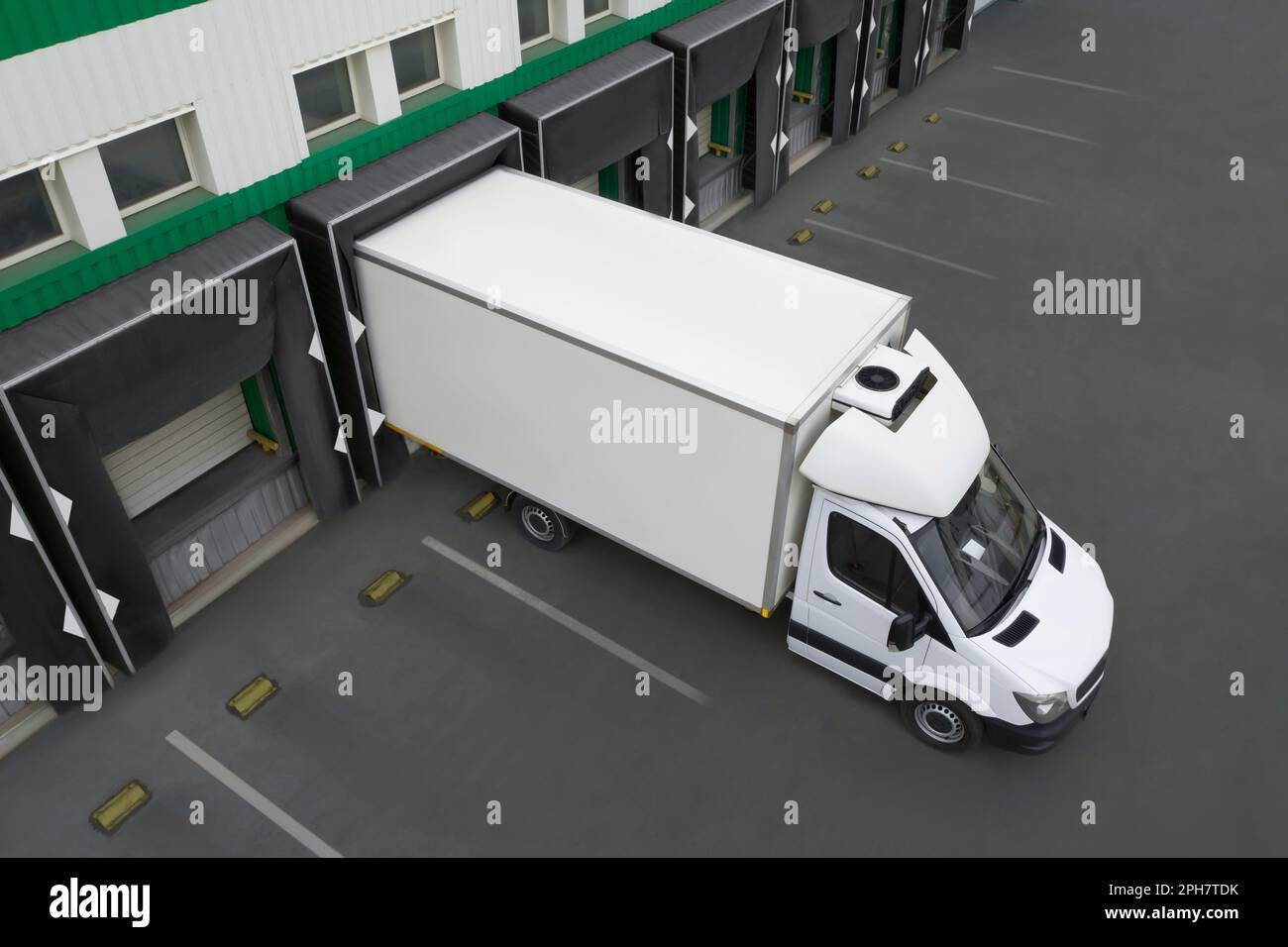 Truck near loading dock of warehouse outdoors, aerial view. Logistics ...
