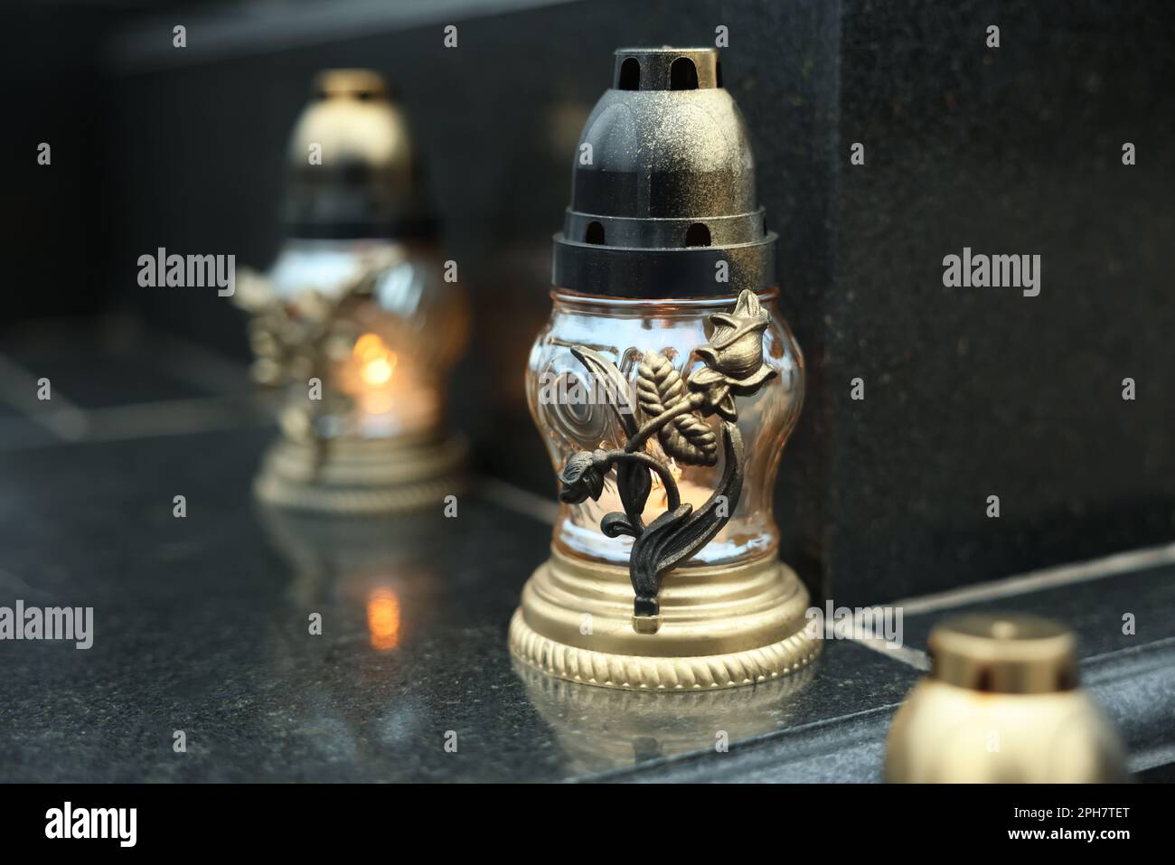Grave lights on granite surface at cemetery Stock Photo - Alamy