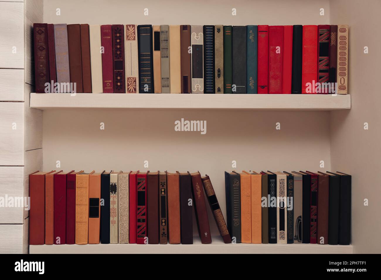 Collection of different books on shelves. Home library Stock Photo - Alamy