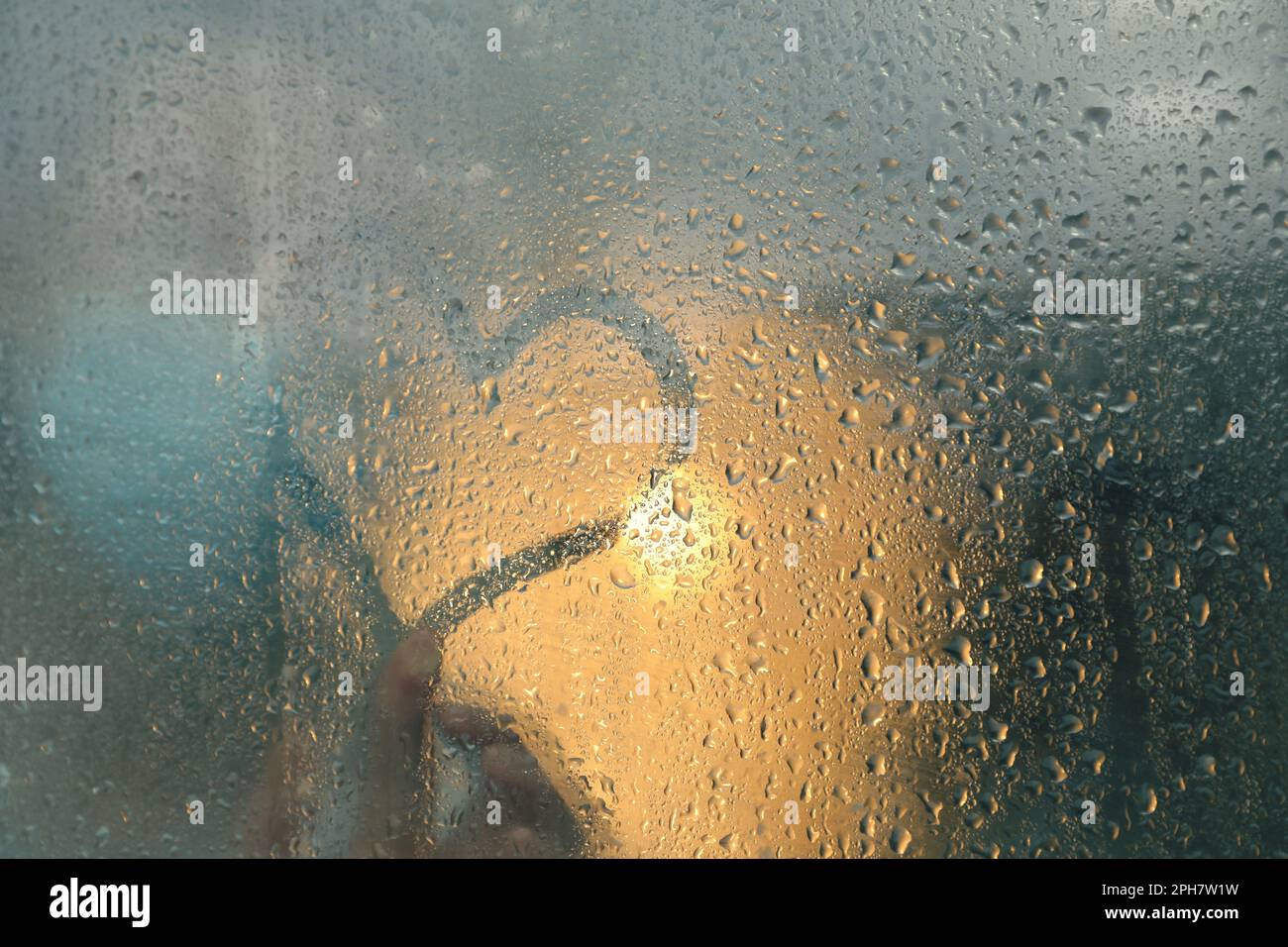 Woman drawing heart on foggy window at rainy weather, closeup Stock ...