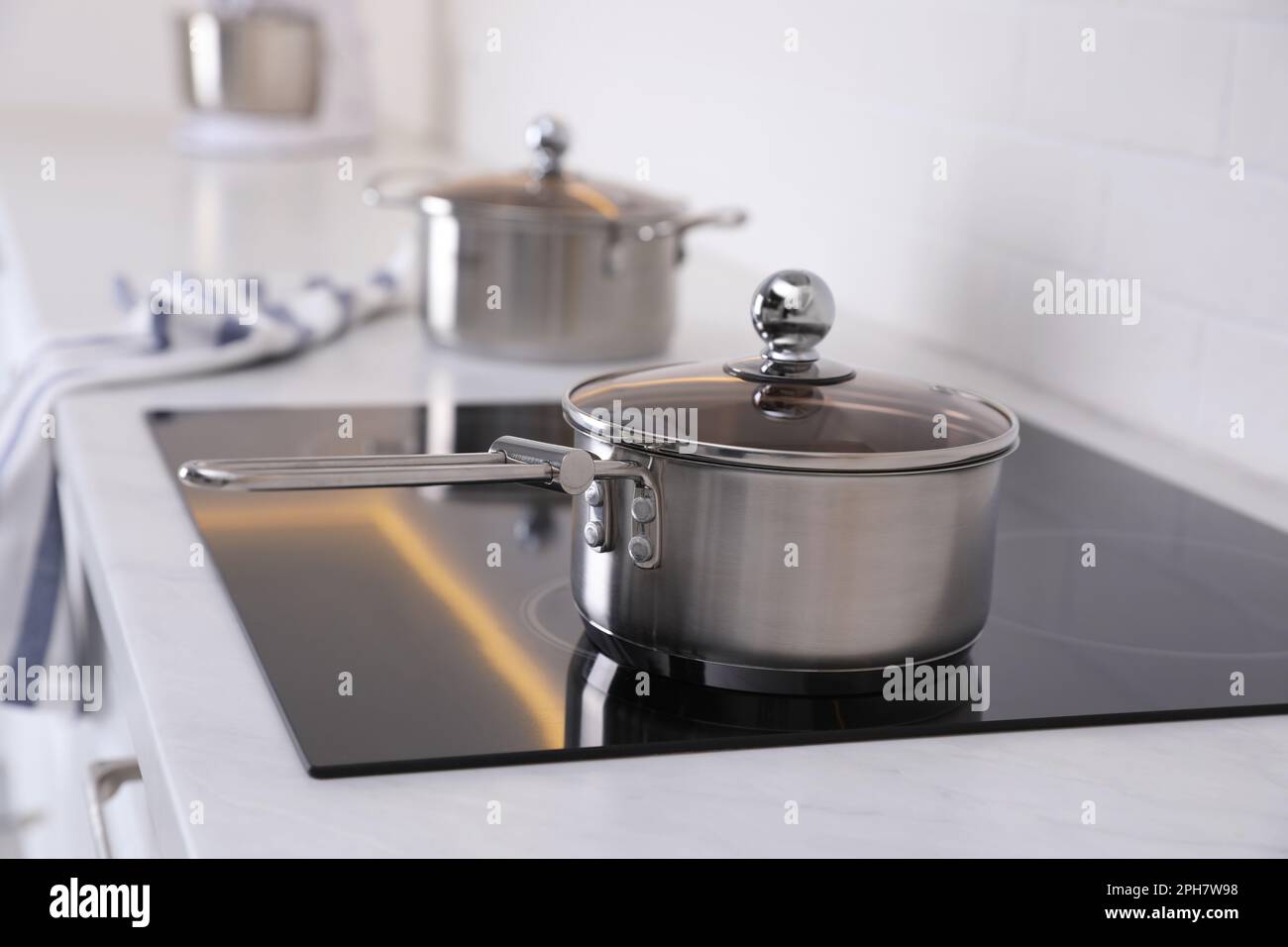 New clean pot on cooktop in kitchen Stock Photo - Alamy