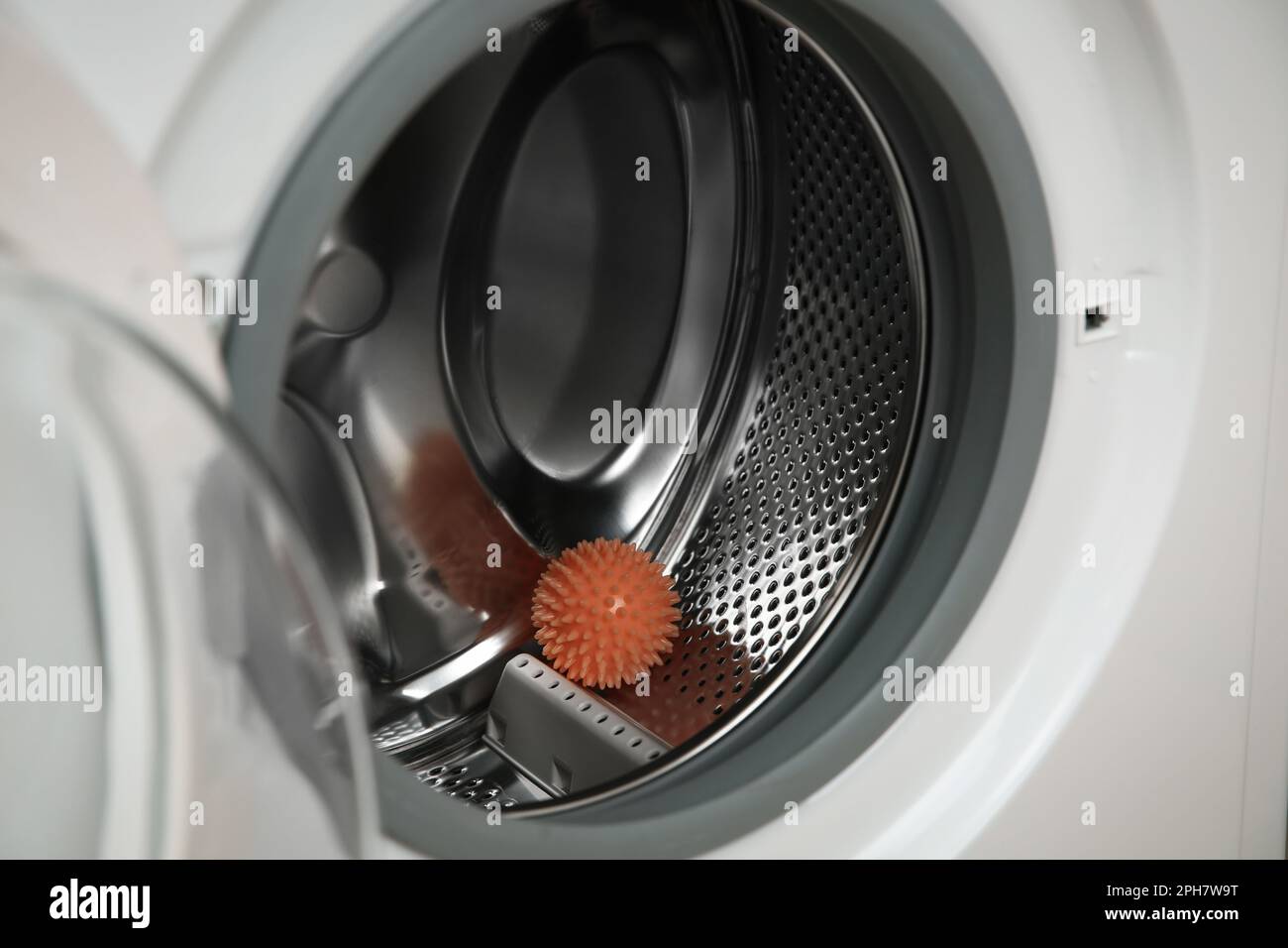 Dryer ball in washing machine drum, closeup Stock Photo - Alamy