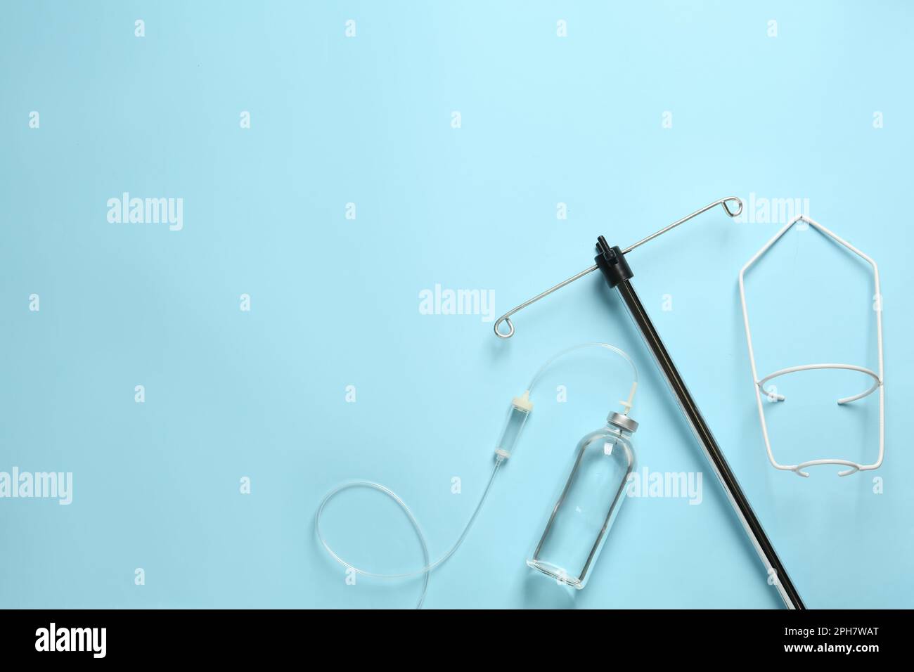 IV infusion set on light blue background, flat lay. Space for text ...