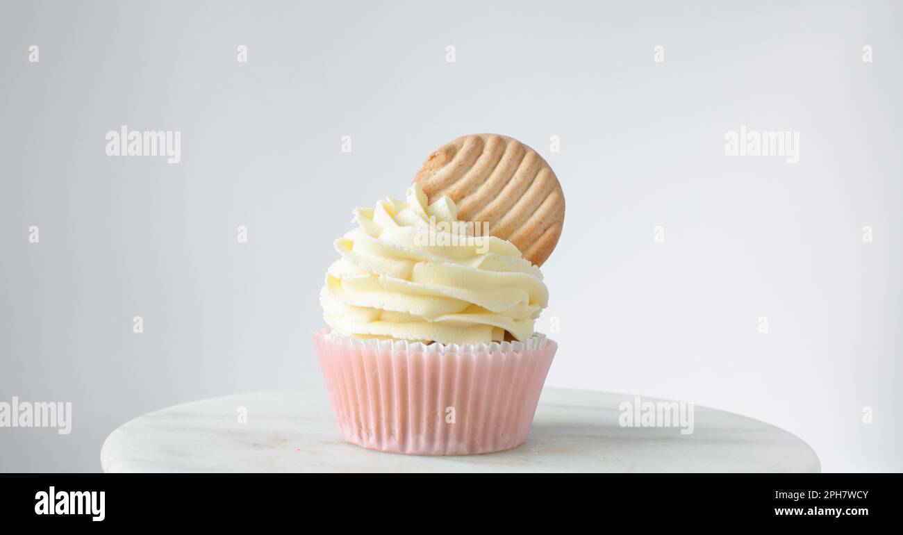 Pink cupcakes with tall american buttercream swirl and cookie garnish ...