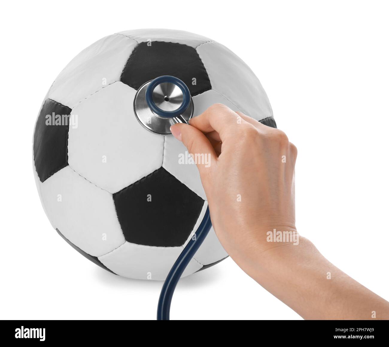 Woman examining soccer ball with stethoscope on white background ...