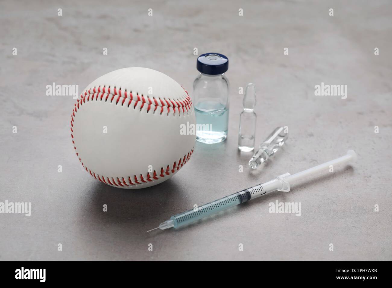 Baseball ball, syringe and drugs on light grey table. Doping concept ...