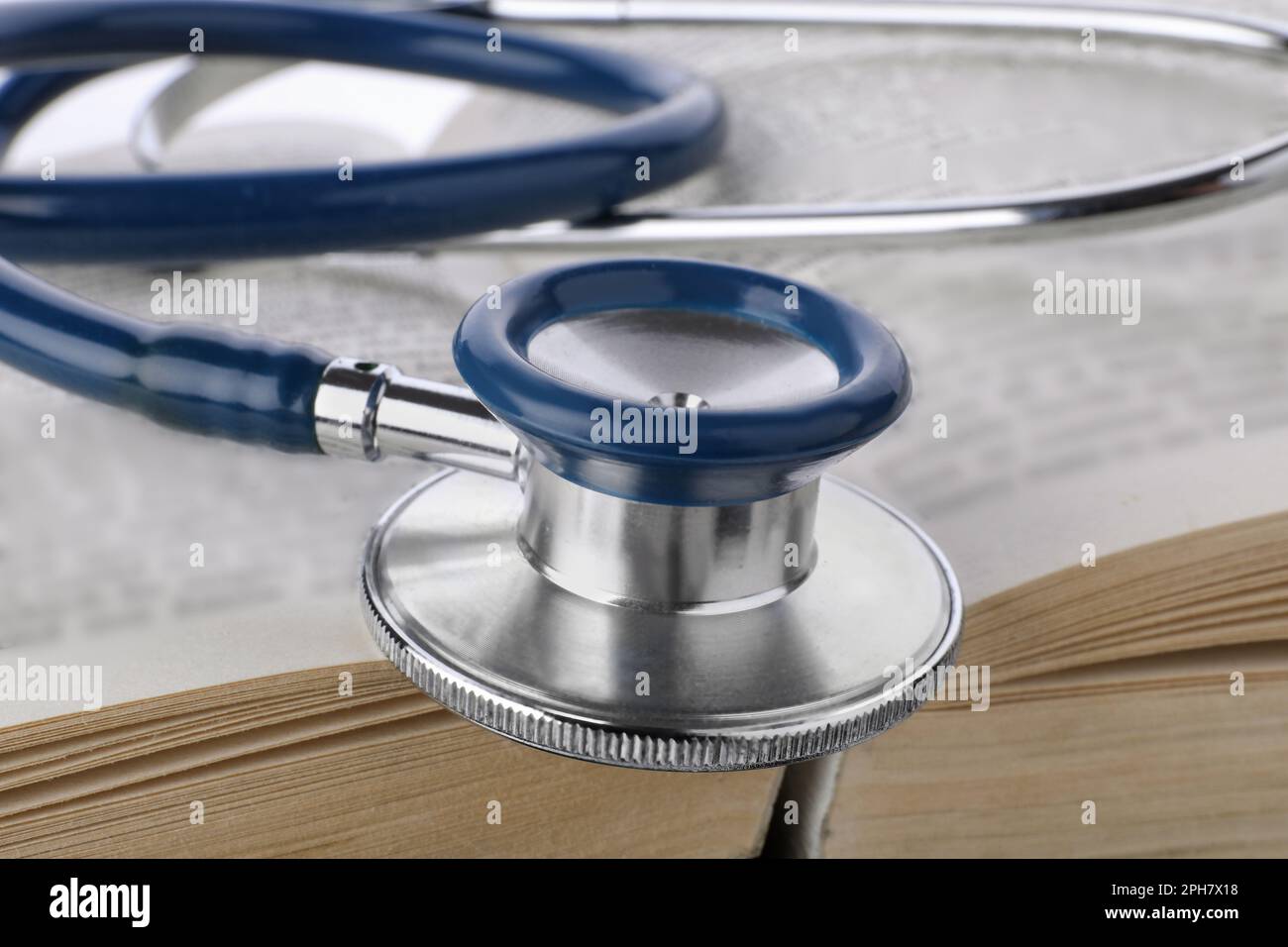 Open student textbook and stethoscope, closeup. Medical education Stock ...